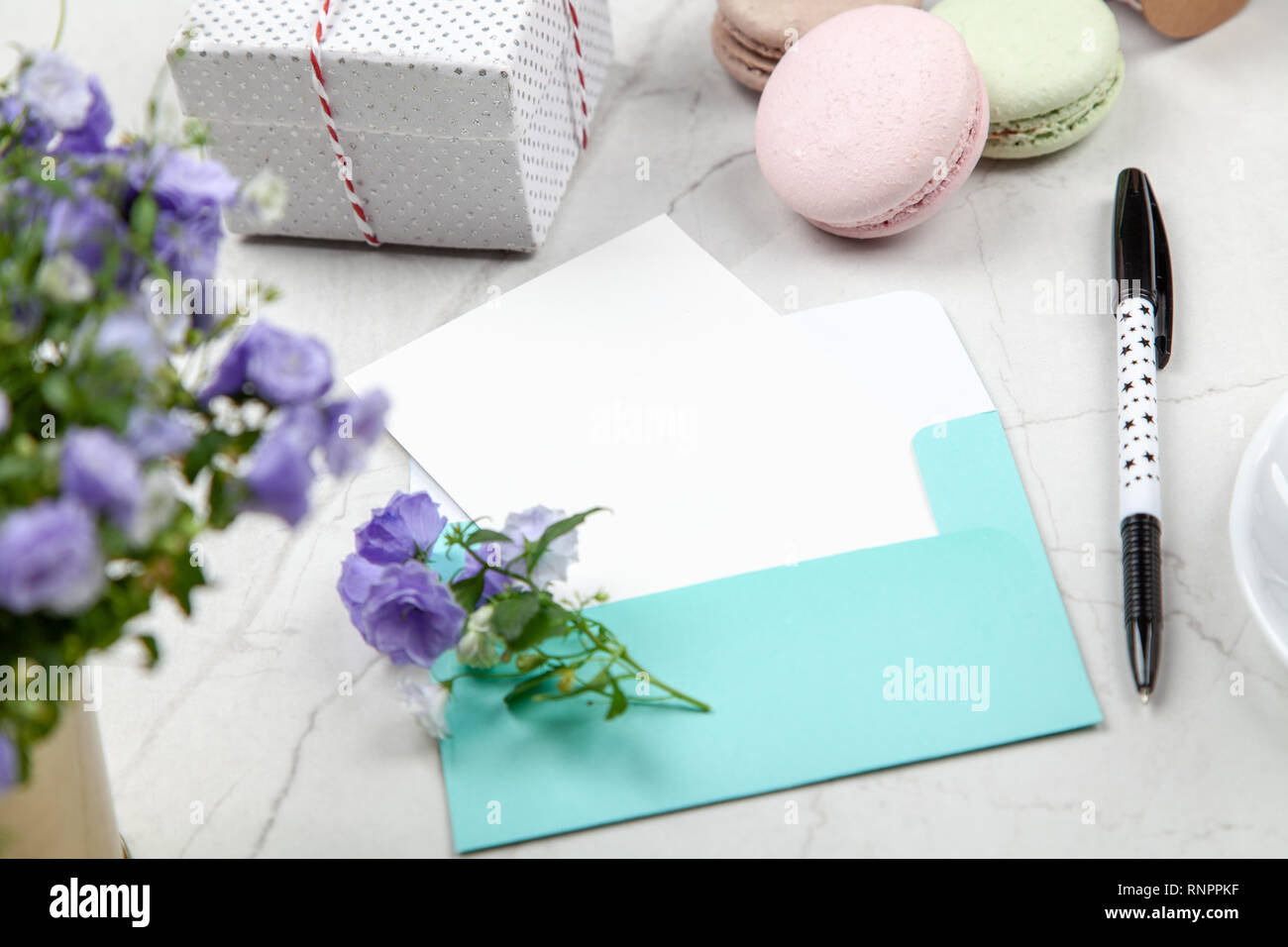 Writing a postcard on white marble table Stock Photo - Alamy