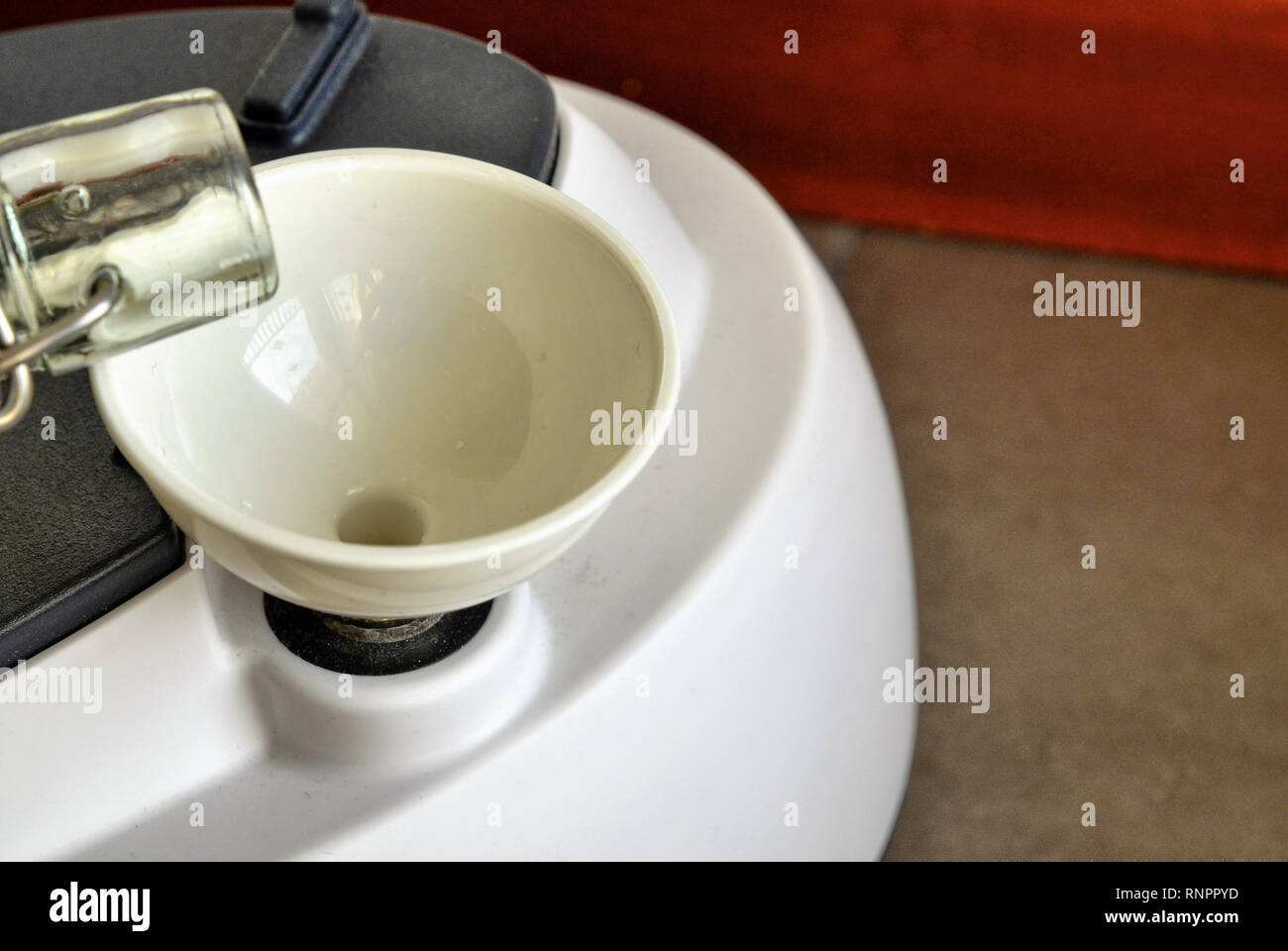 The steam iron boiler is supplied with water: the transparent glass ...