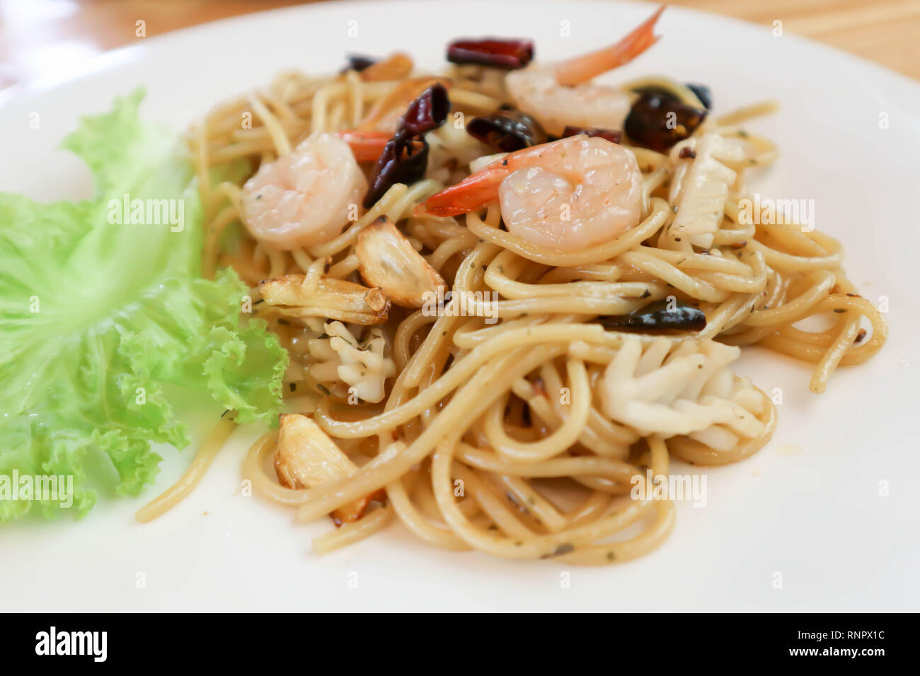 seafood spaghetti or spicy spaghetti in thai style Stock Photo - Alamy