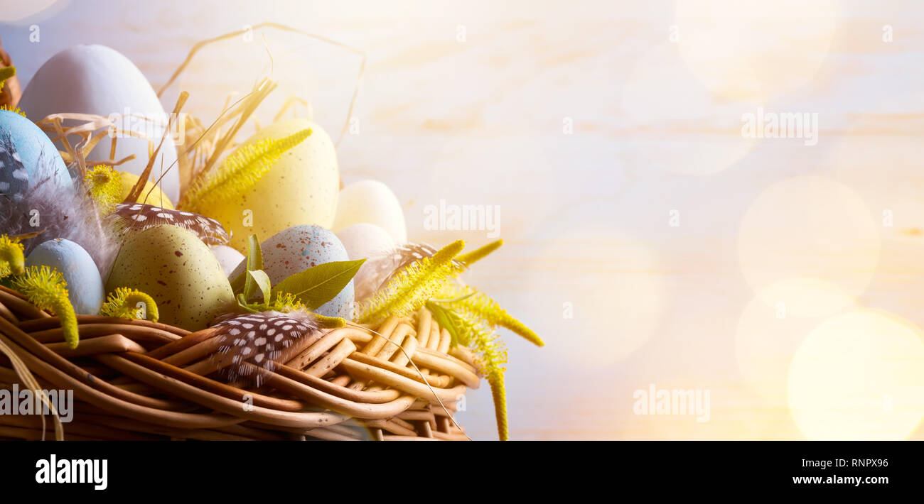 sunny Easter background with Easter eggs in the basket Stock Photo - Alamy