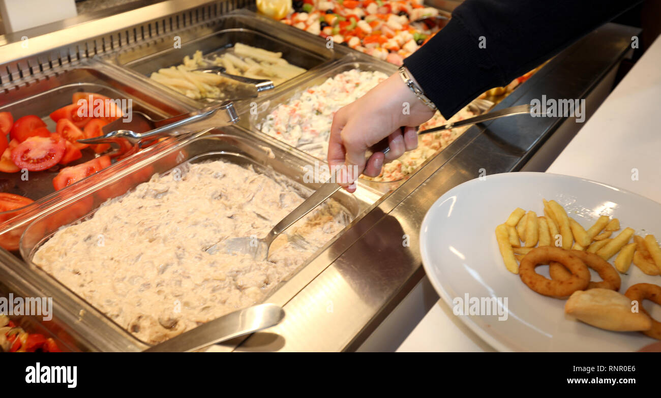 Inside a self service restaurant with many raw and cooked foods Stock ...