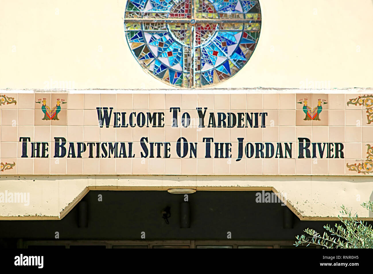 The stained glass and inscription above the central entrance to the ...