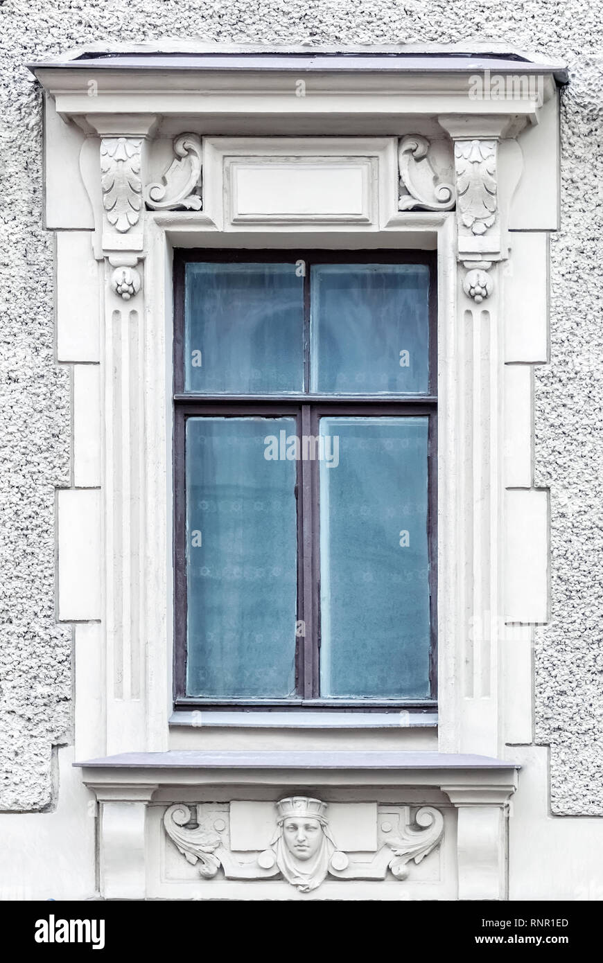 Rectangular window with white stucco on a gray wall background. From a ...