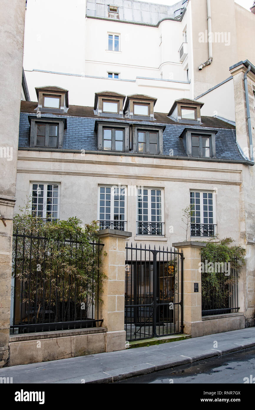 Small house inserted between two buildings Stock Photo - Alamy