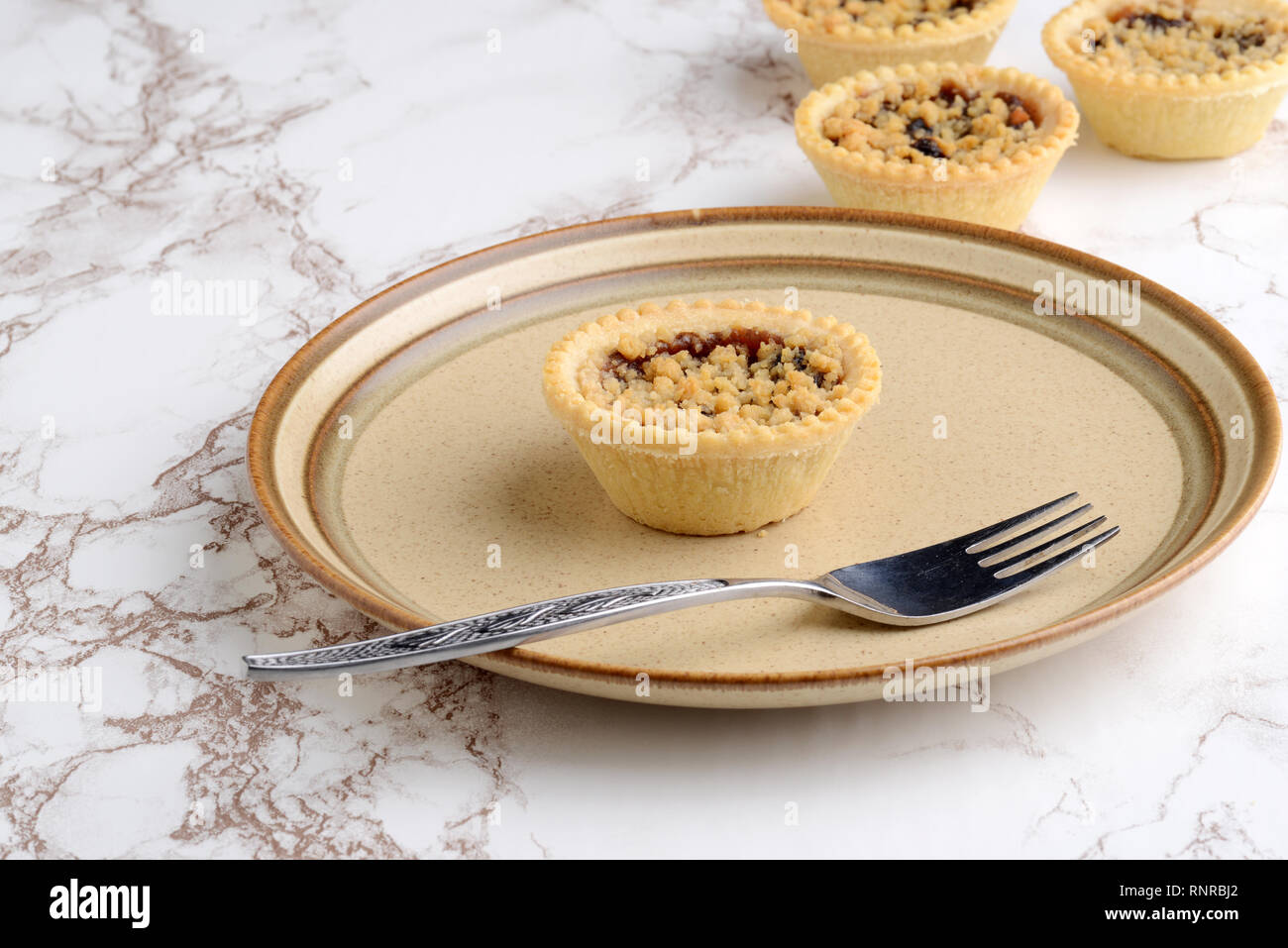 fruit crumble tart with a fork Stock Photo - Alamy