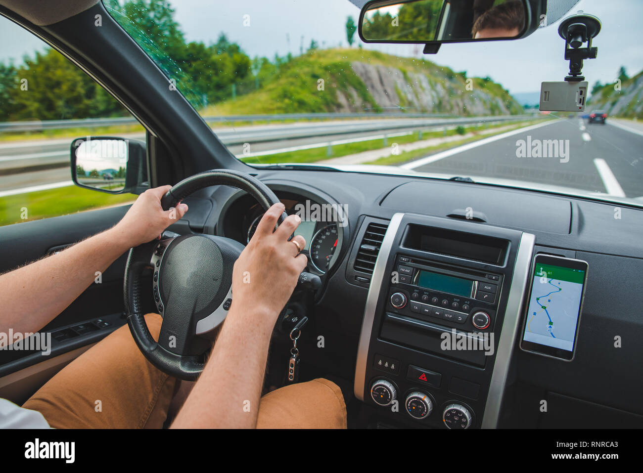 man driving car by speedway. road trip Stock Photo - Alamy