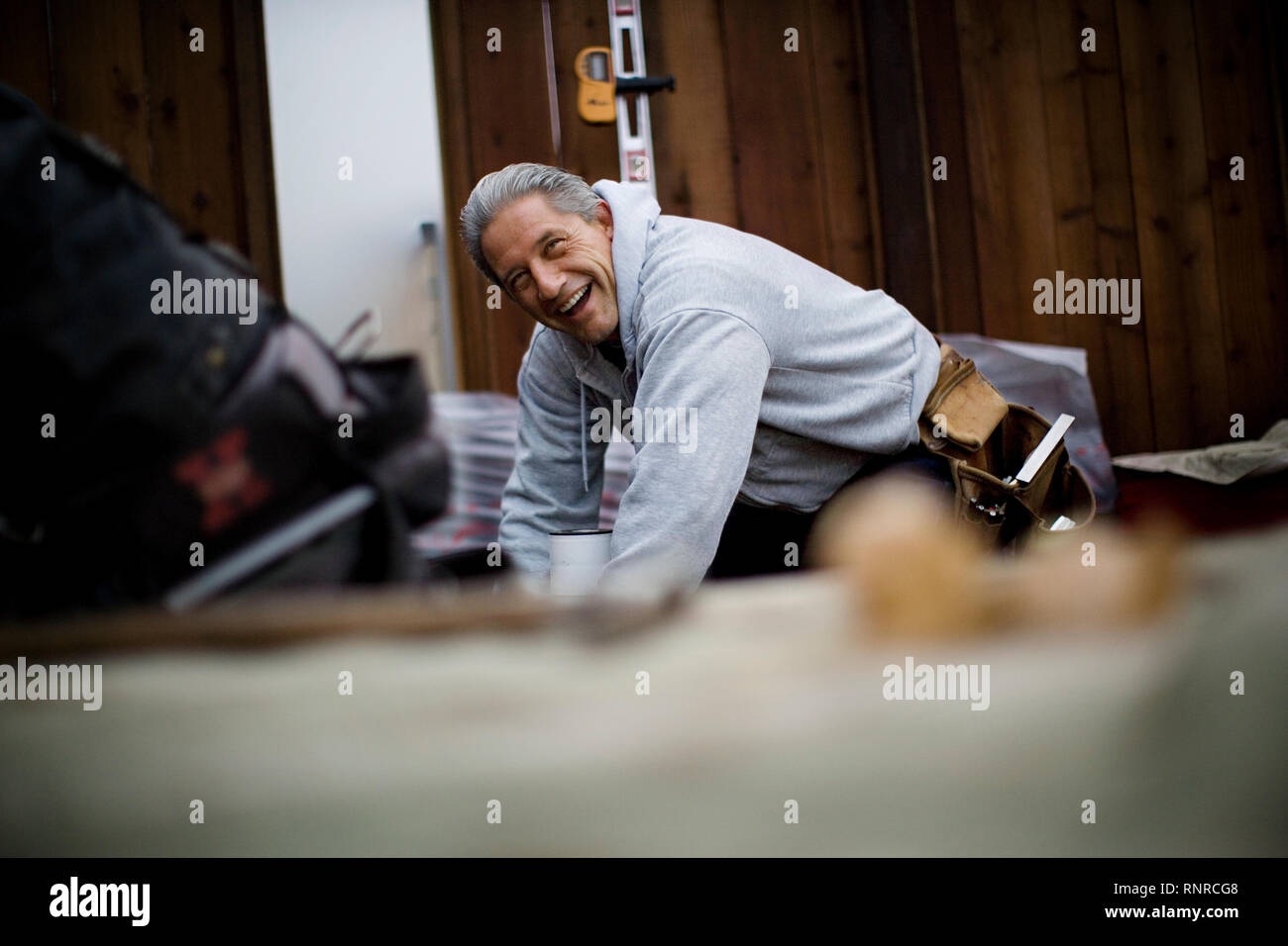 Portrait of a mature construction worker laughing Stock Photo - Alamy