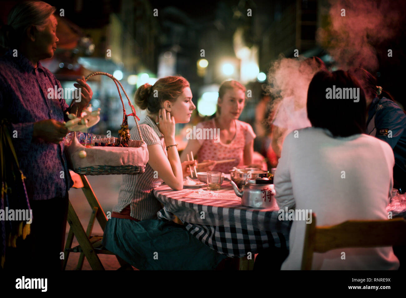 Group of friends having dinner outside at an Asian restaurant Stock ...