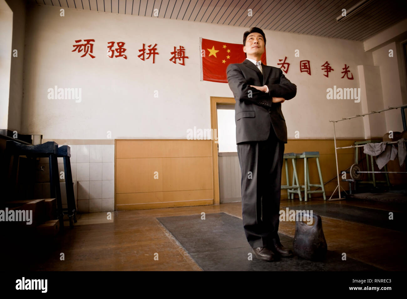Mid-adult male coach standing in a gym Stock Photo - Alamy