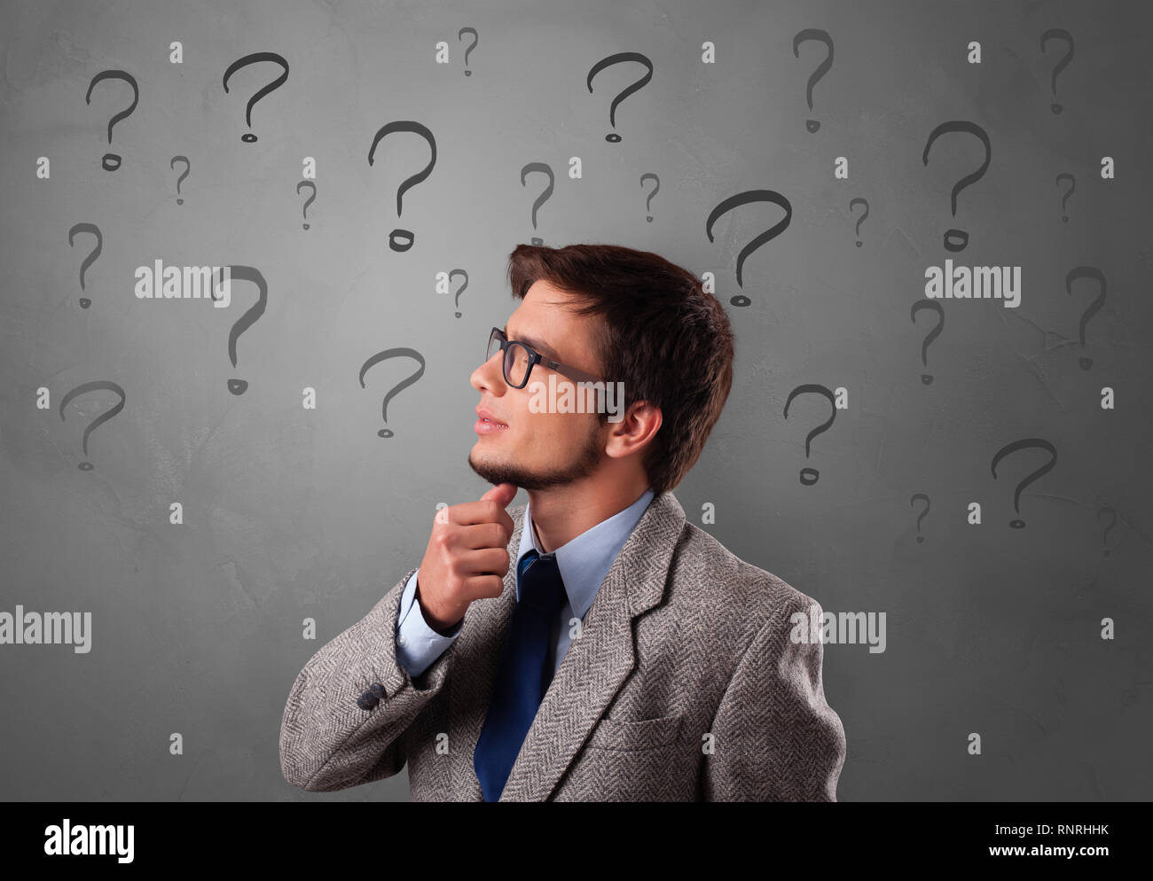 Person with question marks around face Stock Photo - Alamy