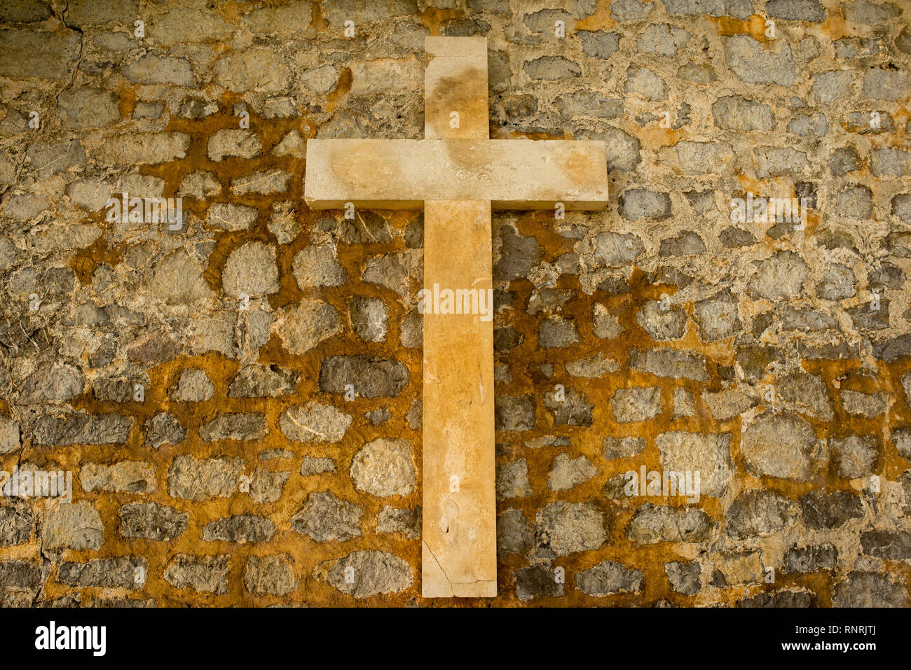 A Christian cross on a stone wall, Spain Stock Photo - Alamy