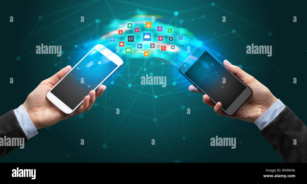 Two mobile phones syncing applications concept Stock Photo - Alamy