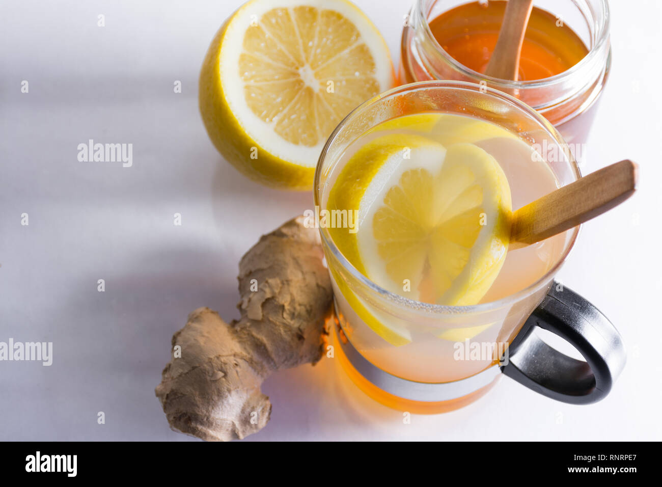 Still life of ginger infusion with ingredients, lemon and honey on a ...