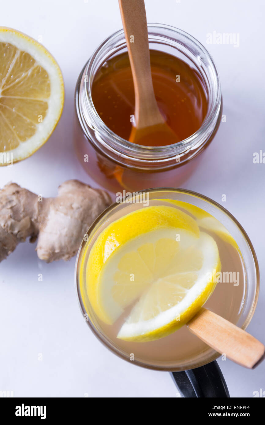 Still life of ginger infusion with ingredients, lemon and honey on a ...