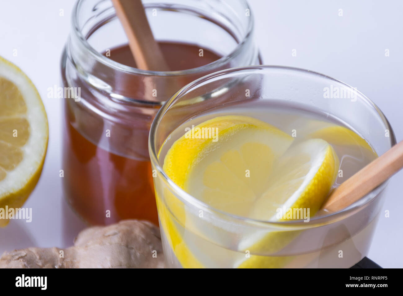Still life of ginger infusion with ingredients, lemon and honey on a ...