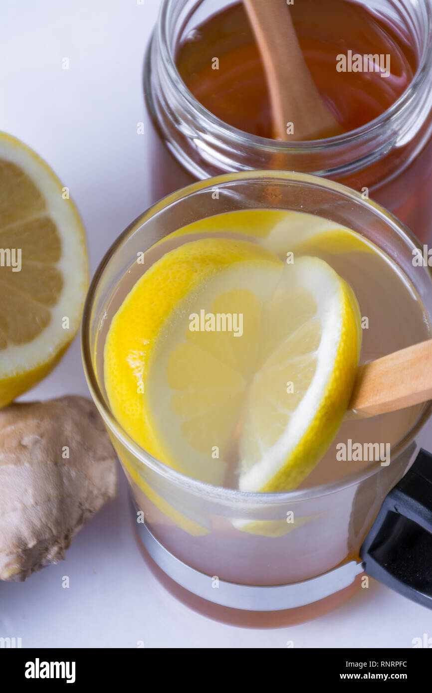 Still life of ginger infusion with ingredients, lemon and honey on a ...