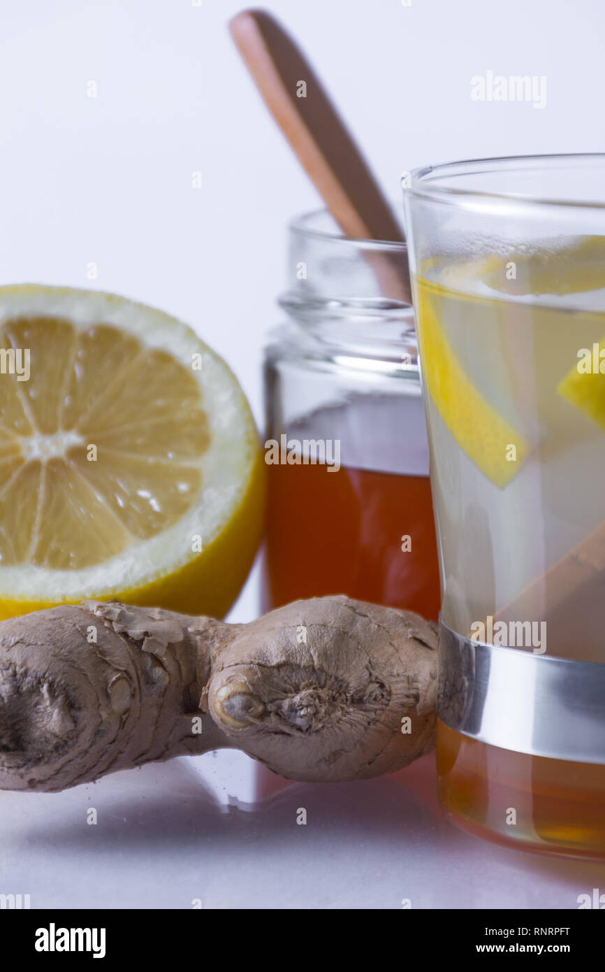 Still life of ginger infusion with ingredients, lemon and honey on a ...