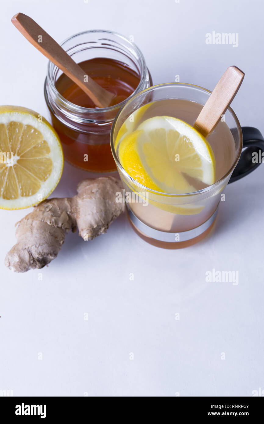 Still life of ginger infusion with ingredients, lemon and honey on a ...