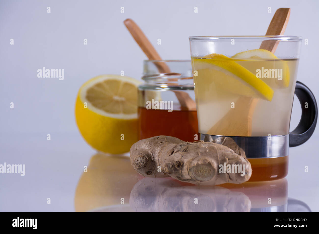 Still life of ginger infusion with ingredients, lemon and honey on a ...