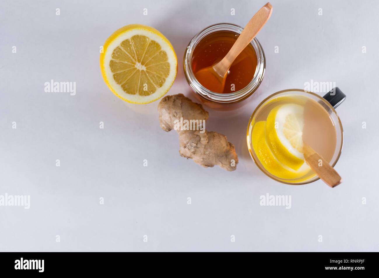 Still life of ginger infusion with ingredients, lemon and honey on a ...