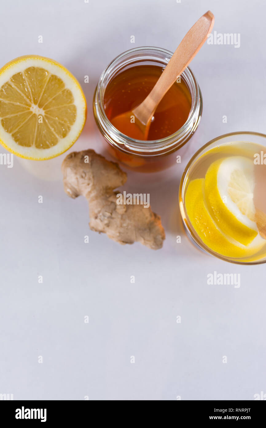 Still life of ginger infusion with ingredients, lemon and honey on a ...