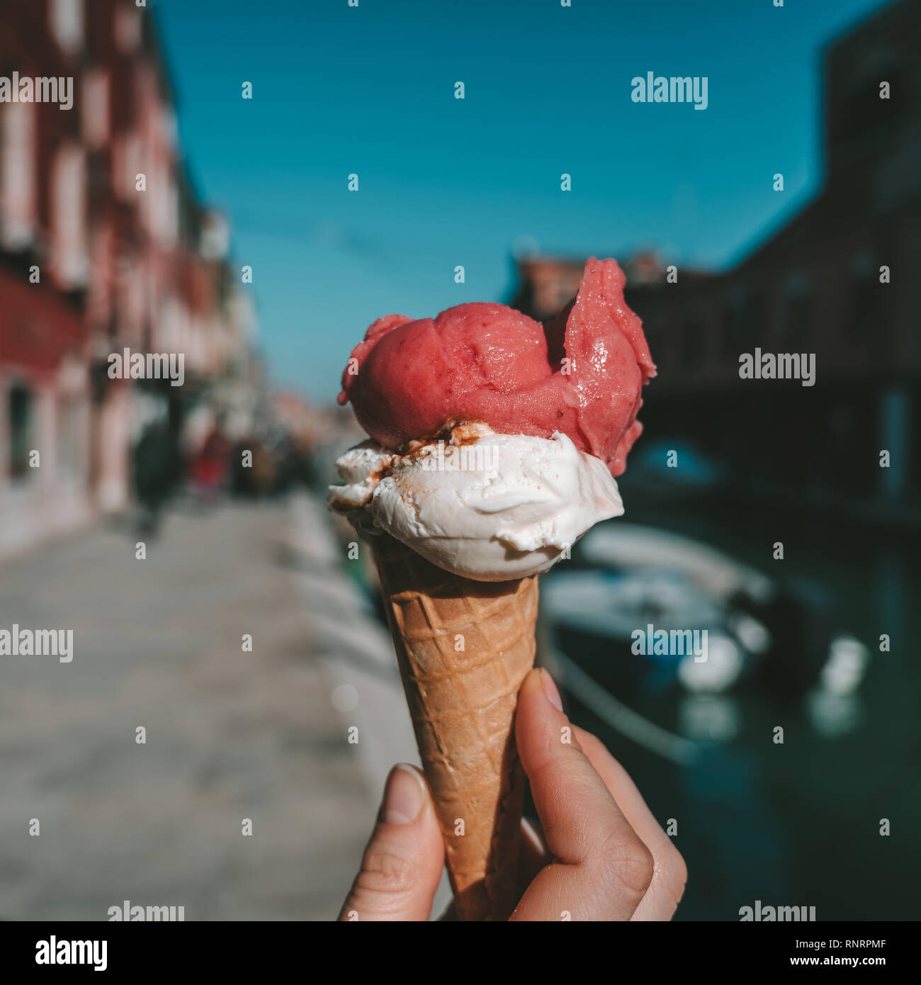 Holding traditional italian ice cream called Gelato in the waffle cone ...