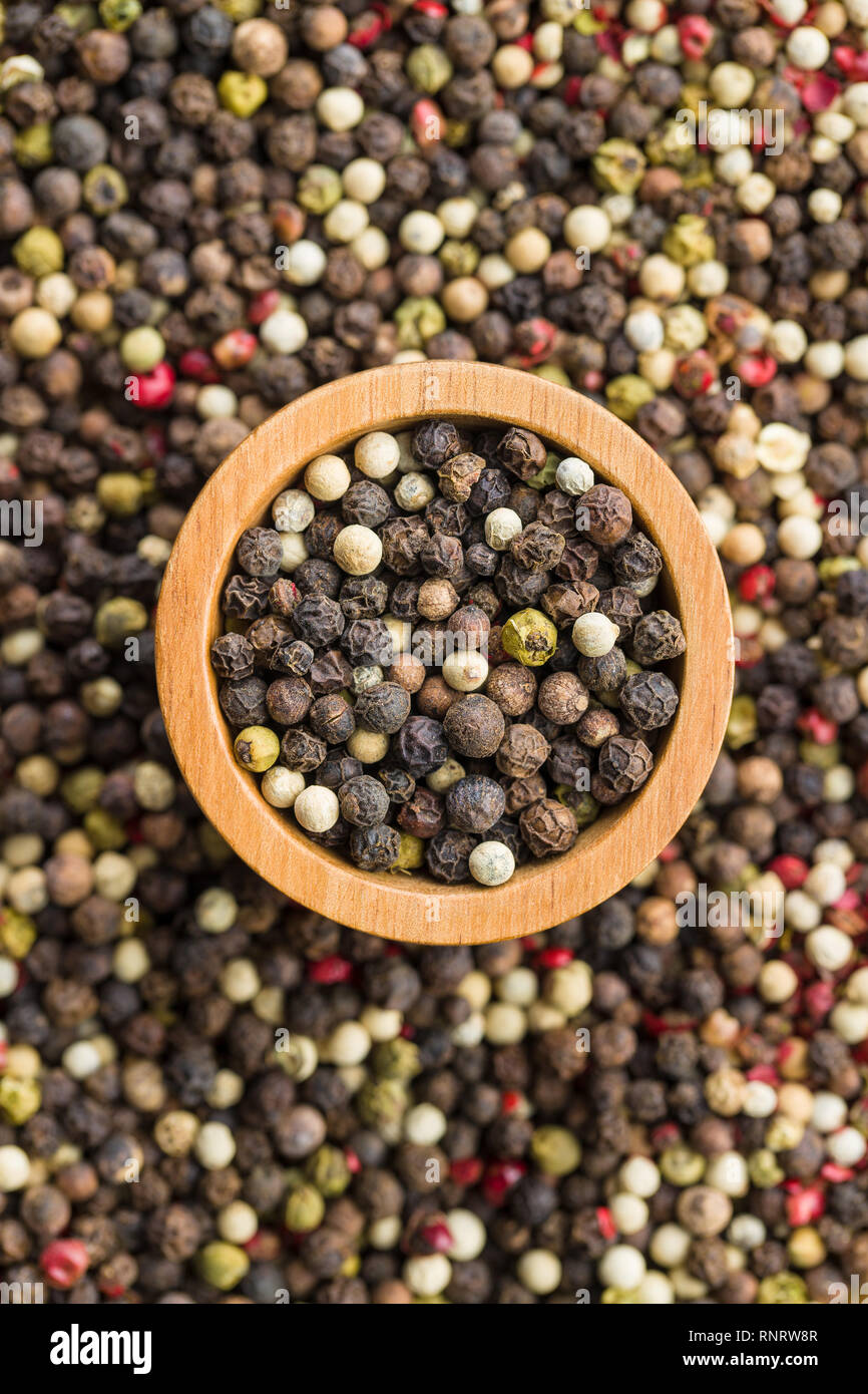 Different types of dried peppercorn in bowl. Top view Stock Photo - Alamy