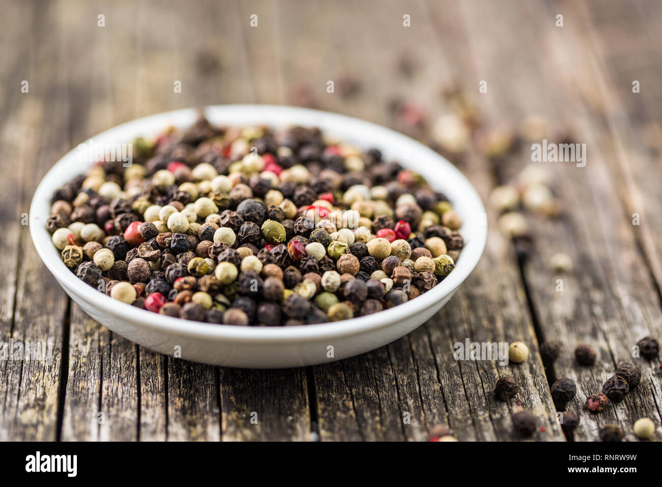 Different types of dried peppercorn in bowl Stock Photo - Alamy