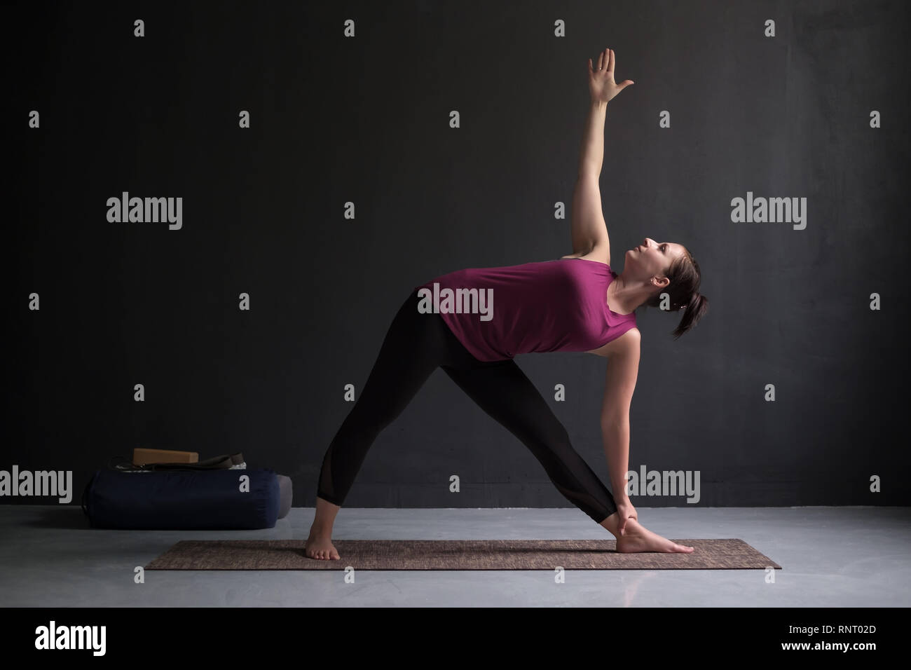 Girl standing in Utthita Trikonasana, extended triangle pose Stock ...