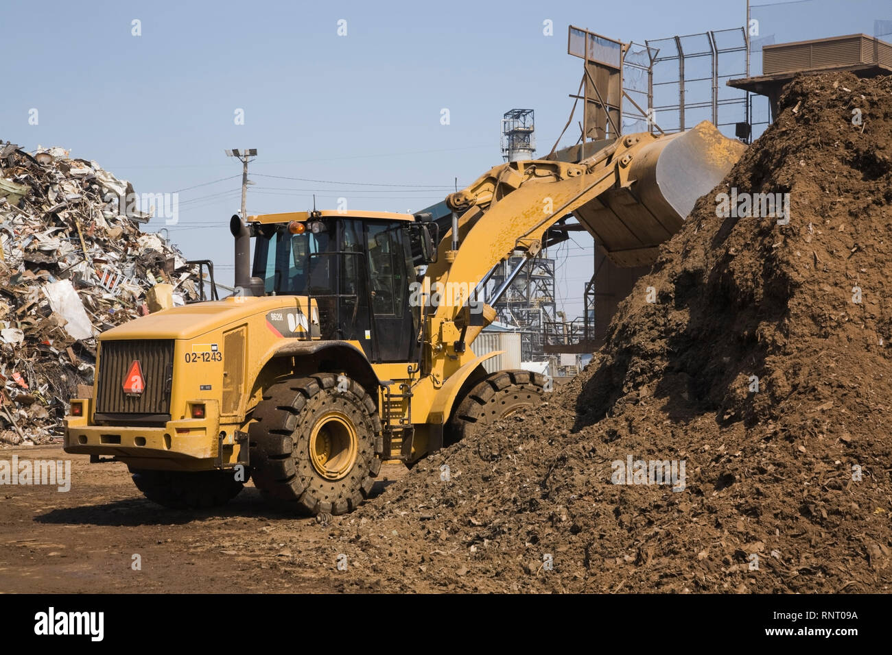 Bucket loader and pile of dirt at a scrap metal recycling yard Stock ...