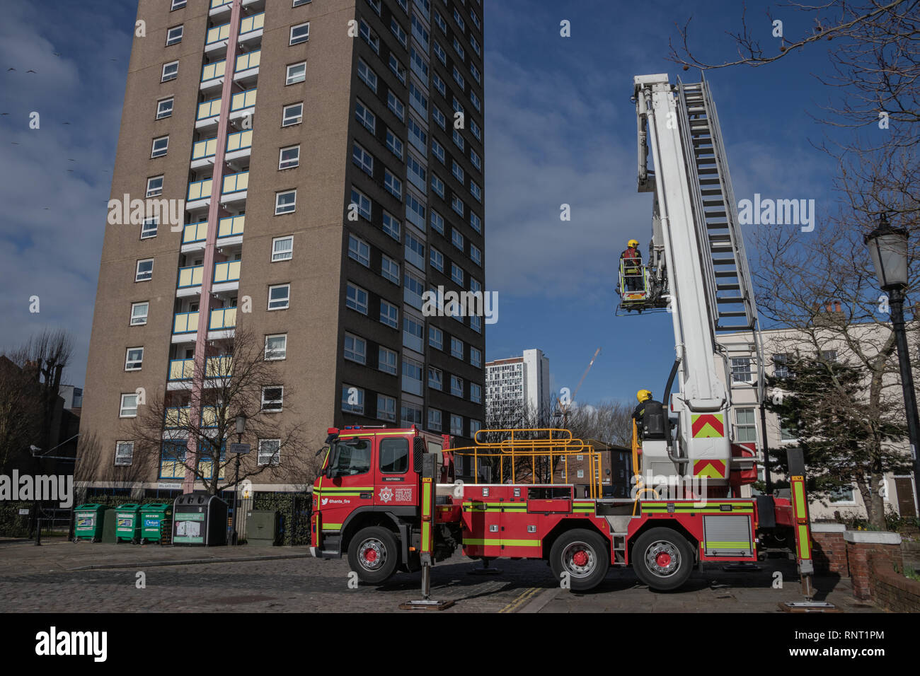 Fire and rescue, UK in cherry picker with tower block Stock Photo - Alamy
