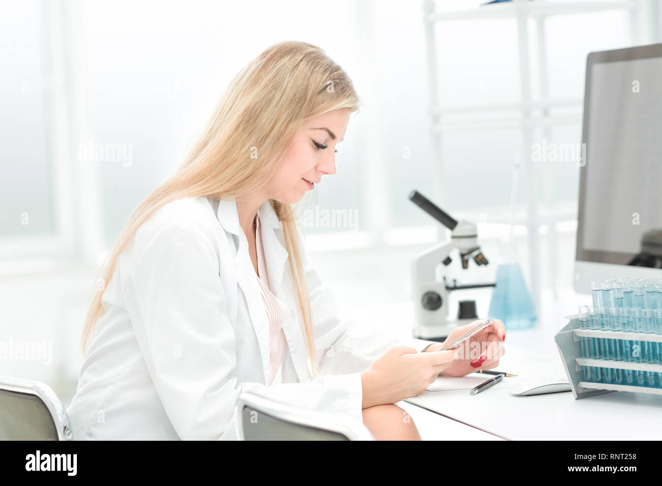 female scientist uses smartphone in the workplace Stock Photo - Alamy