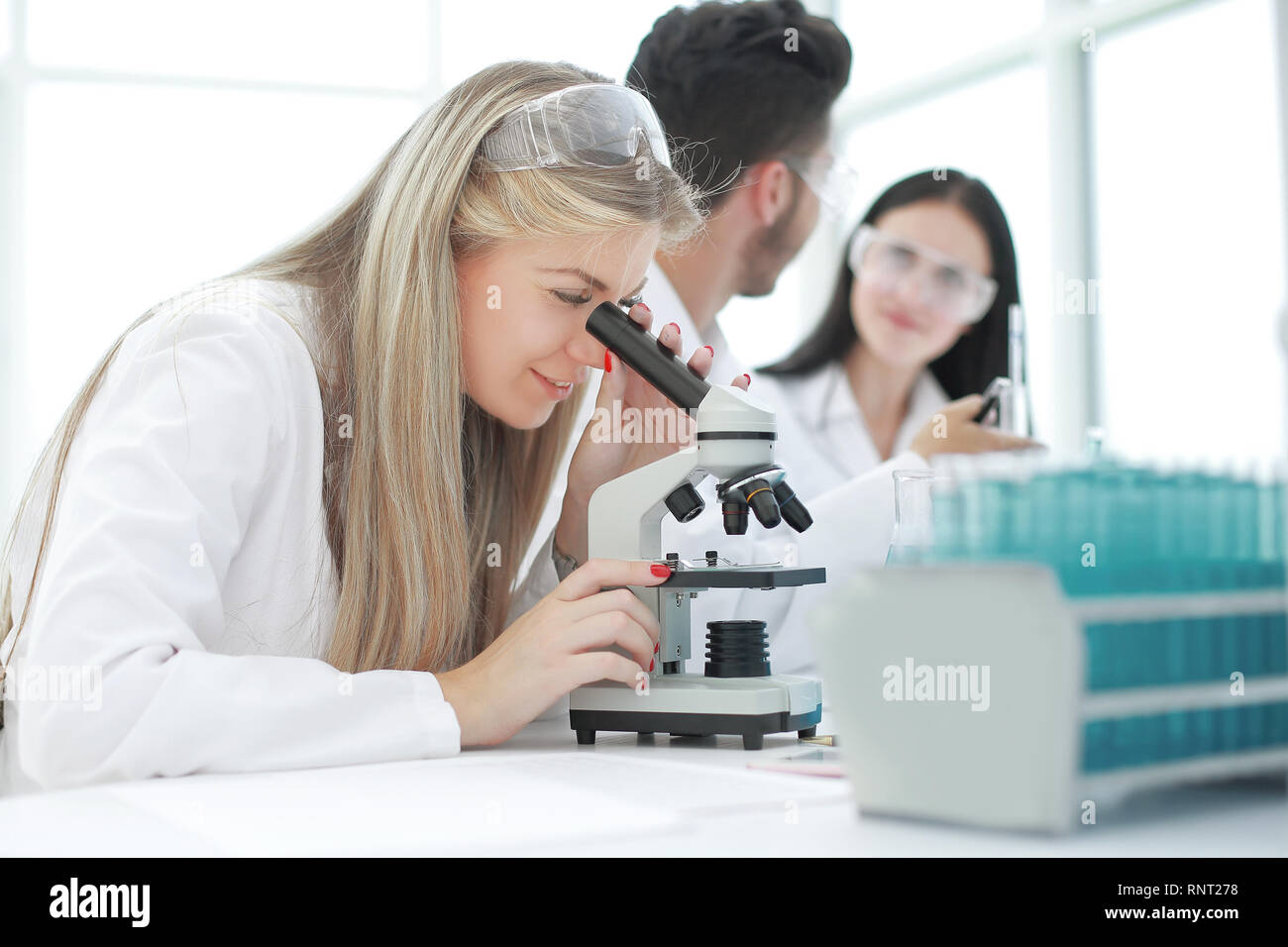 close up. a group of scientists conduct research in a modern laboratory ...