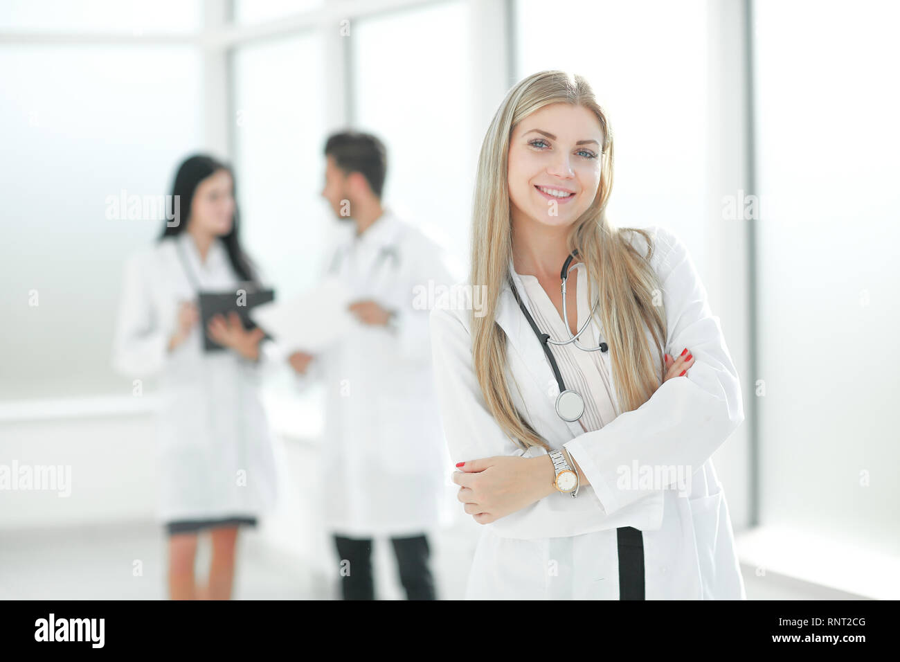 young pediatrician doctor standing in the hallway of the medical center ...