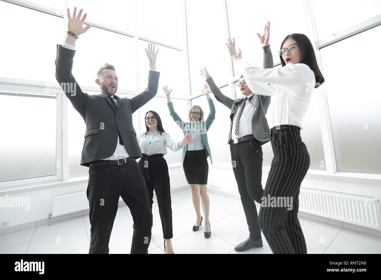 young business team holding their hands up Stock Photo - Alamy
