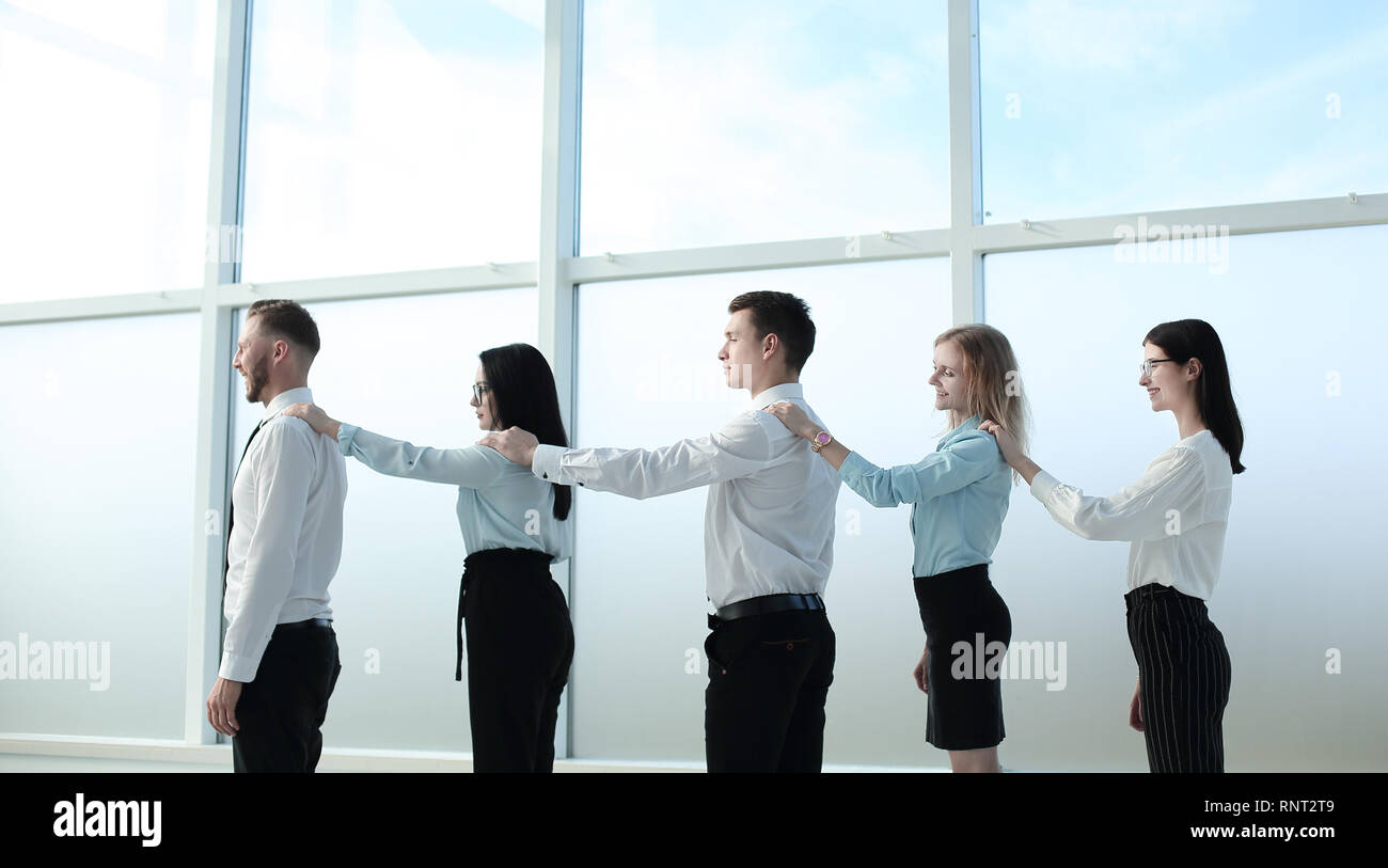 business team standing together near the office window Stock Photo - Alamy