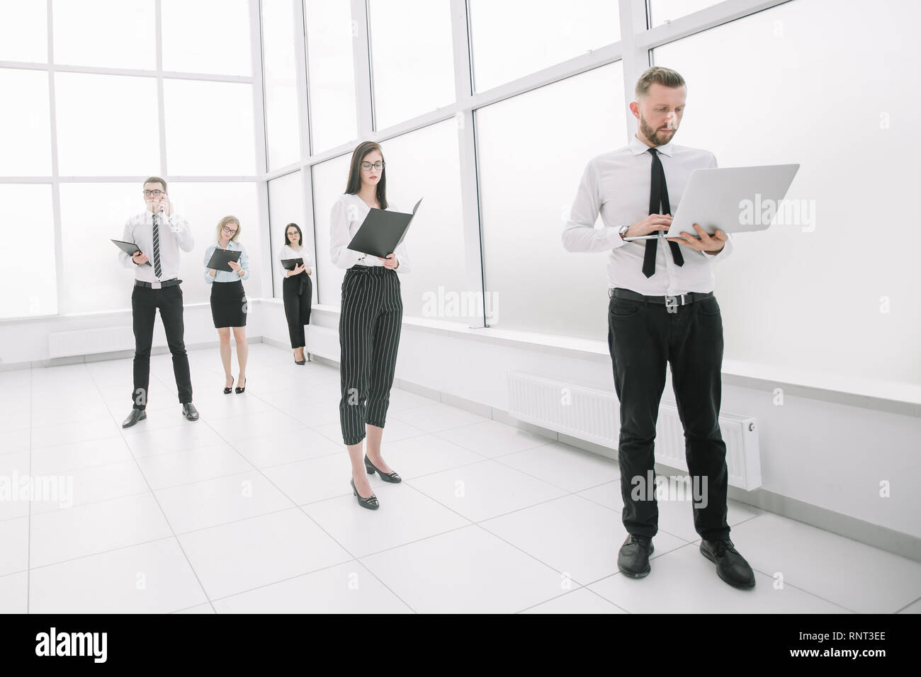 Executive employees of the company standing in the office lobby Stock ...