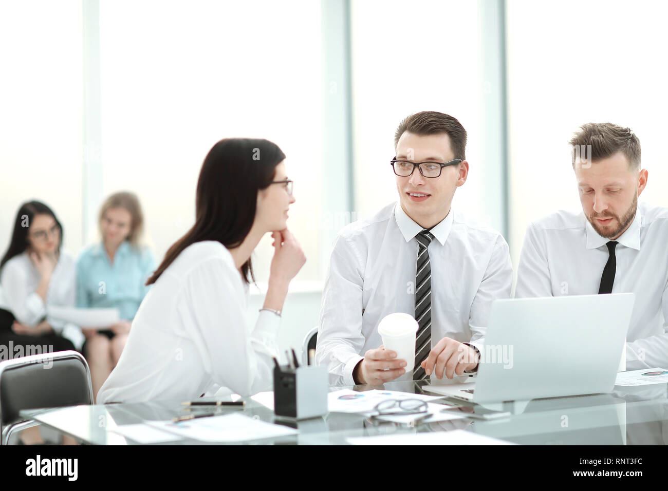 serious employees sitting at the office Desk Stock Photo - Alamy