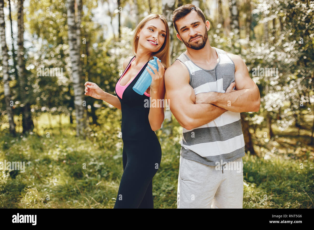 Sports couple in a morning summer park Stock Photo - Alamy