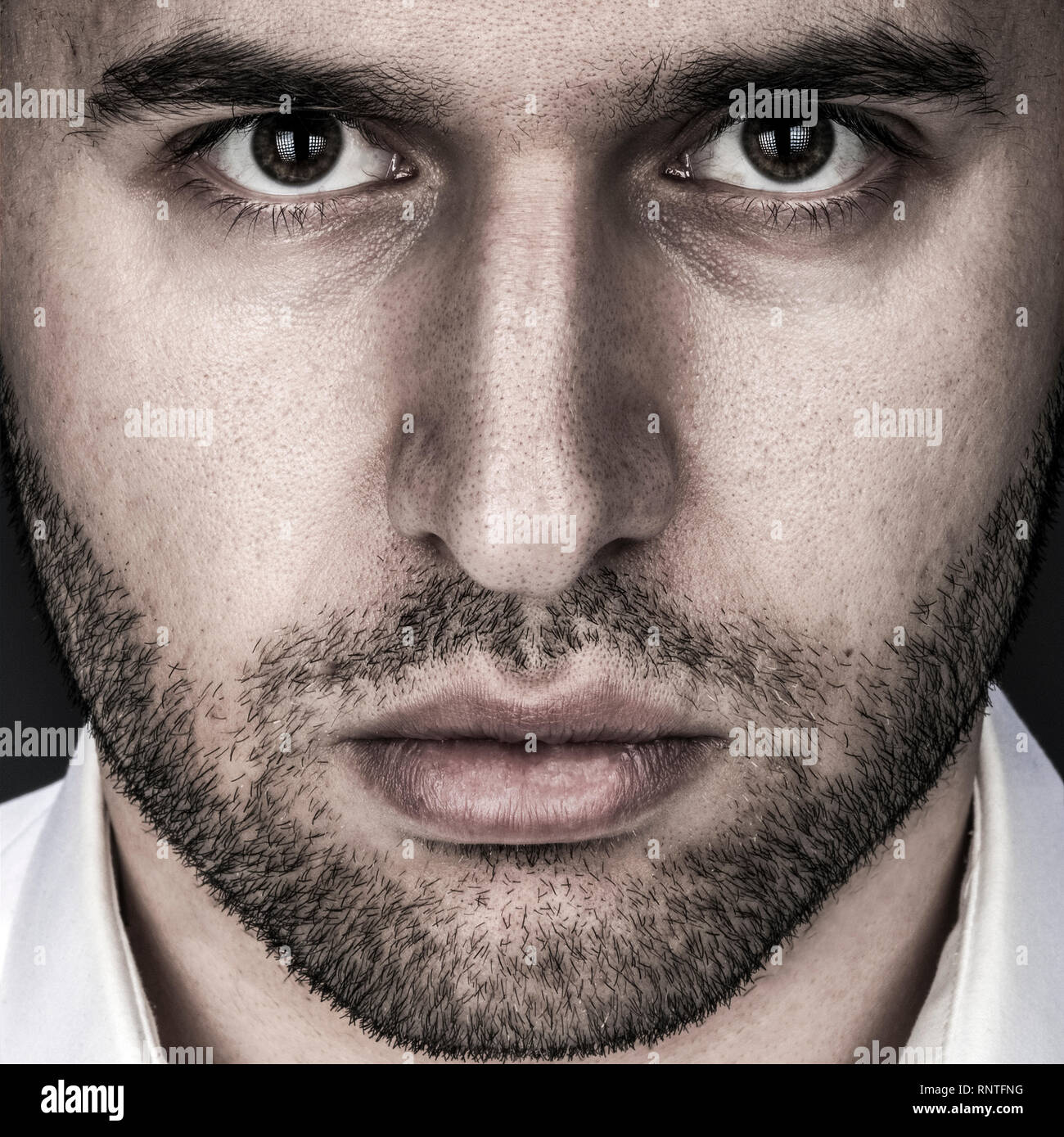 portrait of a strict businessman in a white shirt on a black background ...