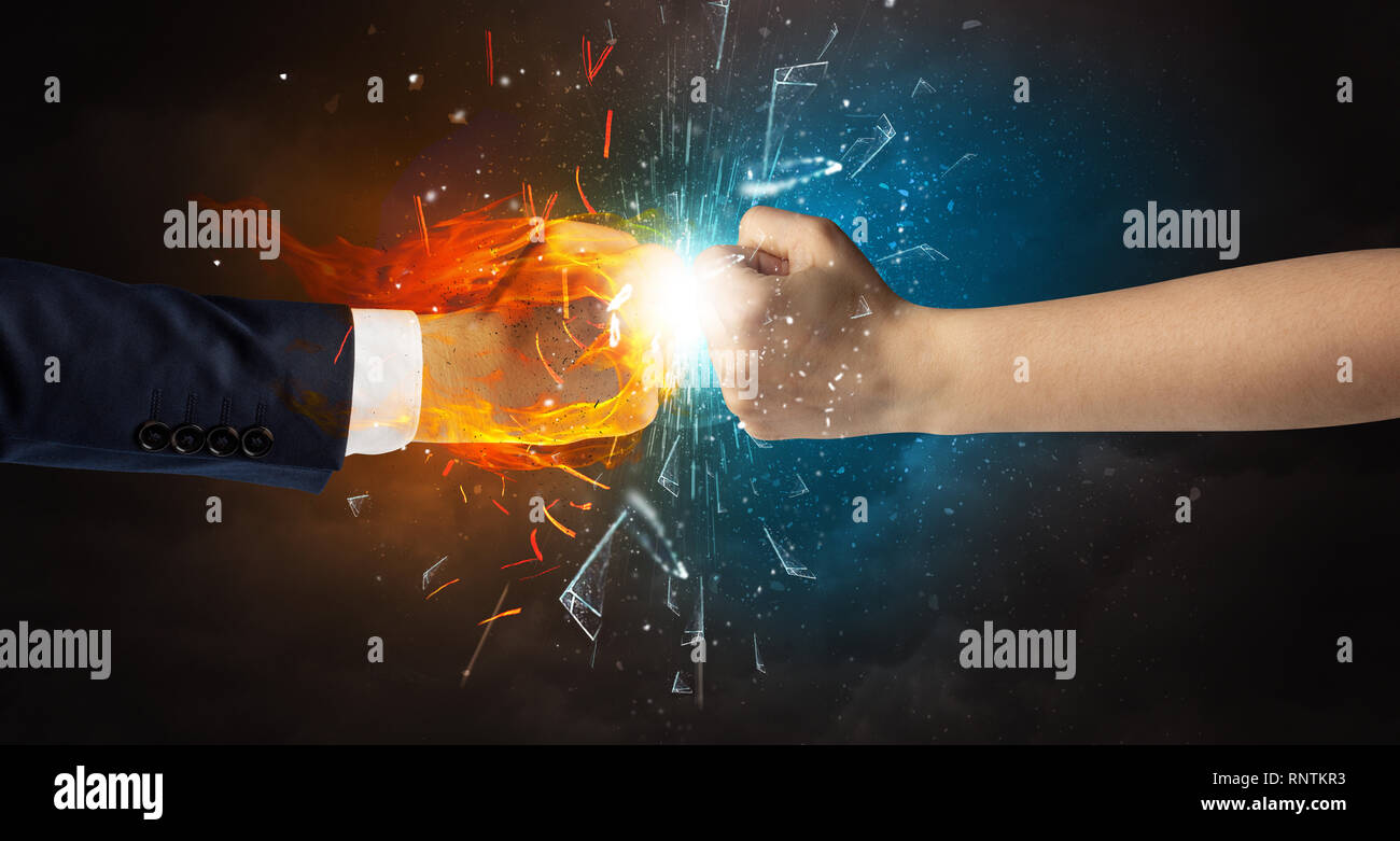 Two hands fighting and breaking glass into small pieces with fire and ...