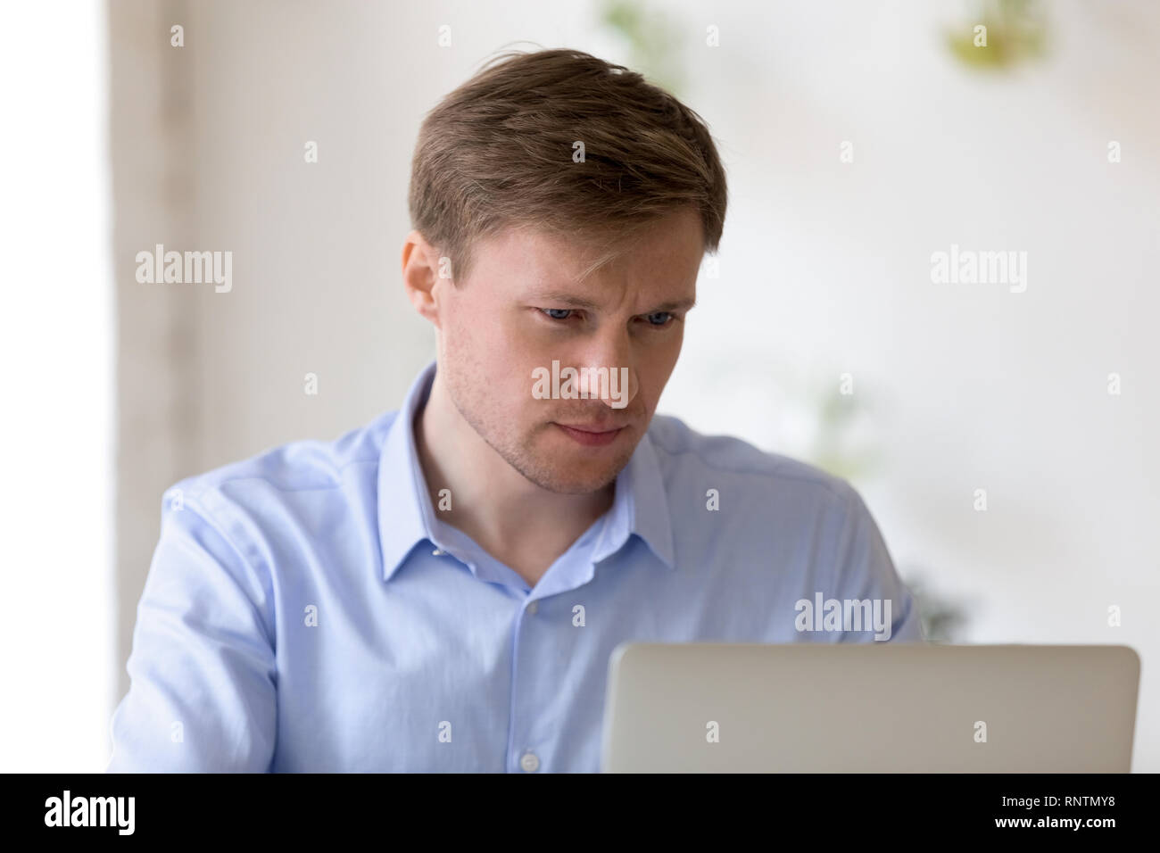 Pensive busy business man working on computer Stock Photo - Alamy
