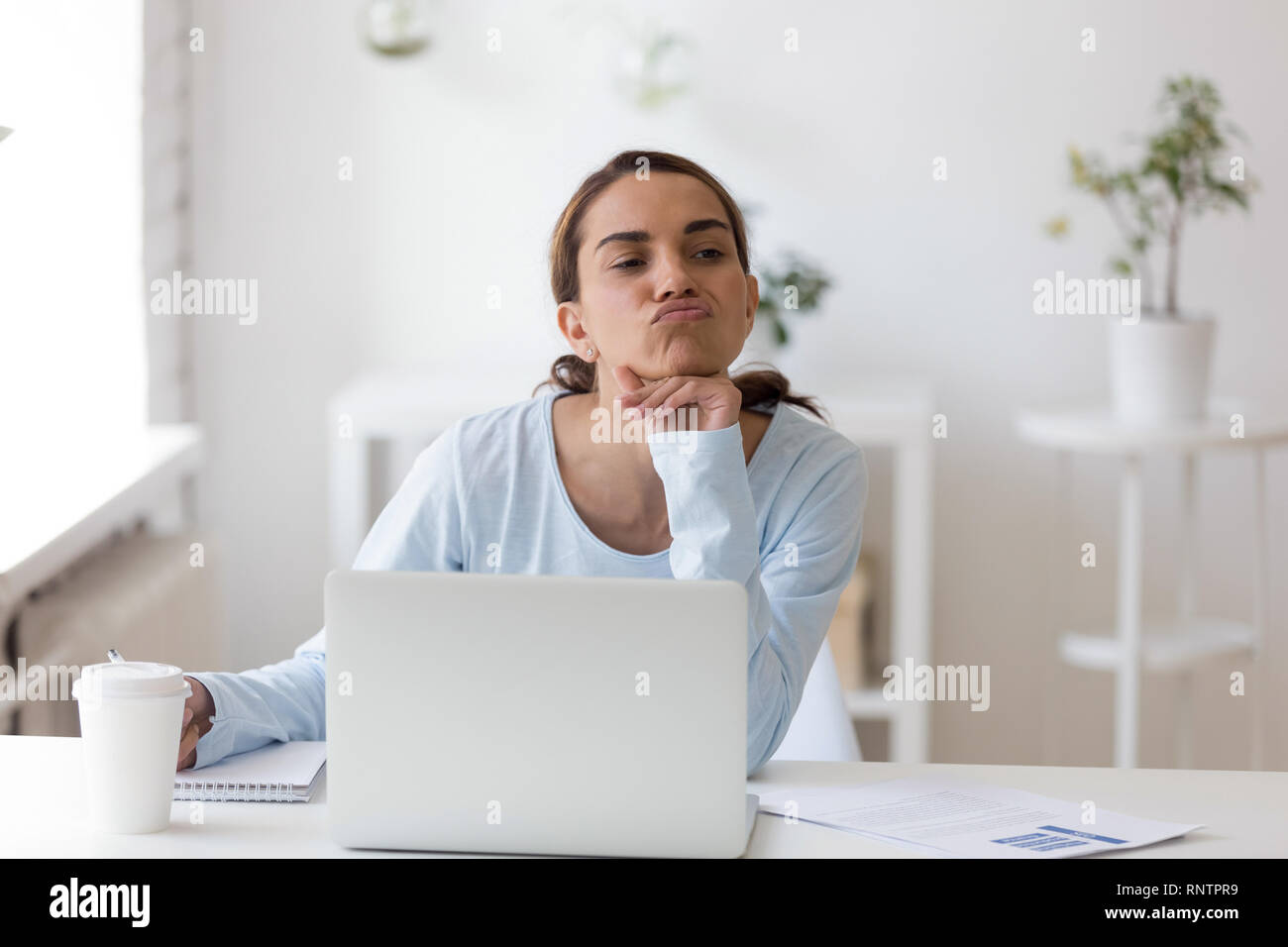 Employee tired to work taking a break making funny face Stock Photo - Alamy