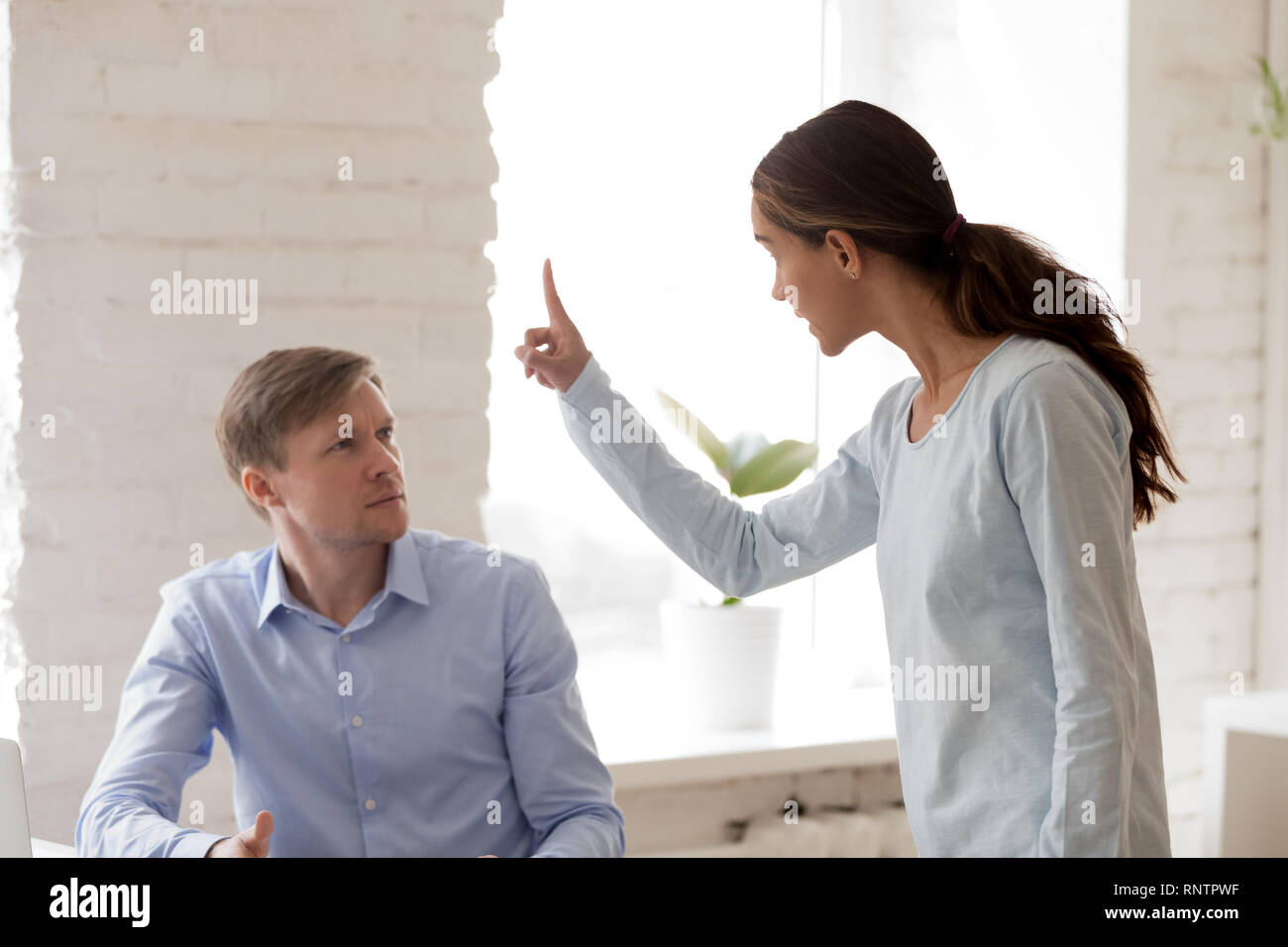 Angry female accusing colleague man at workplace Stock Photo - Alamy