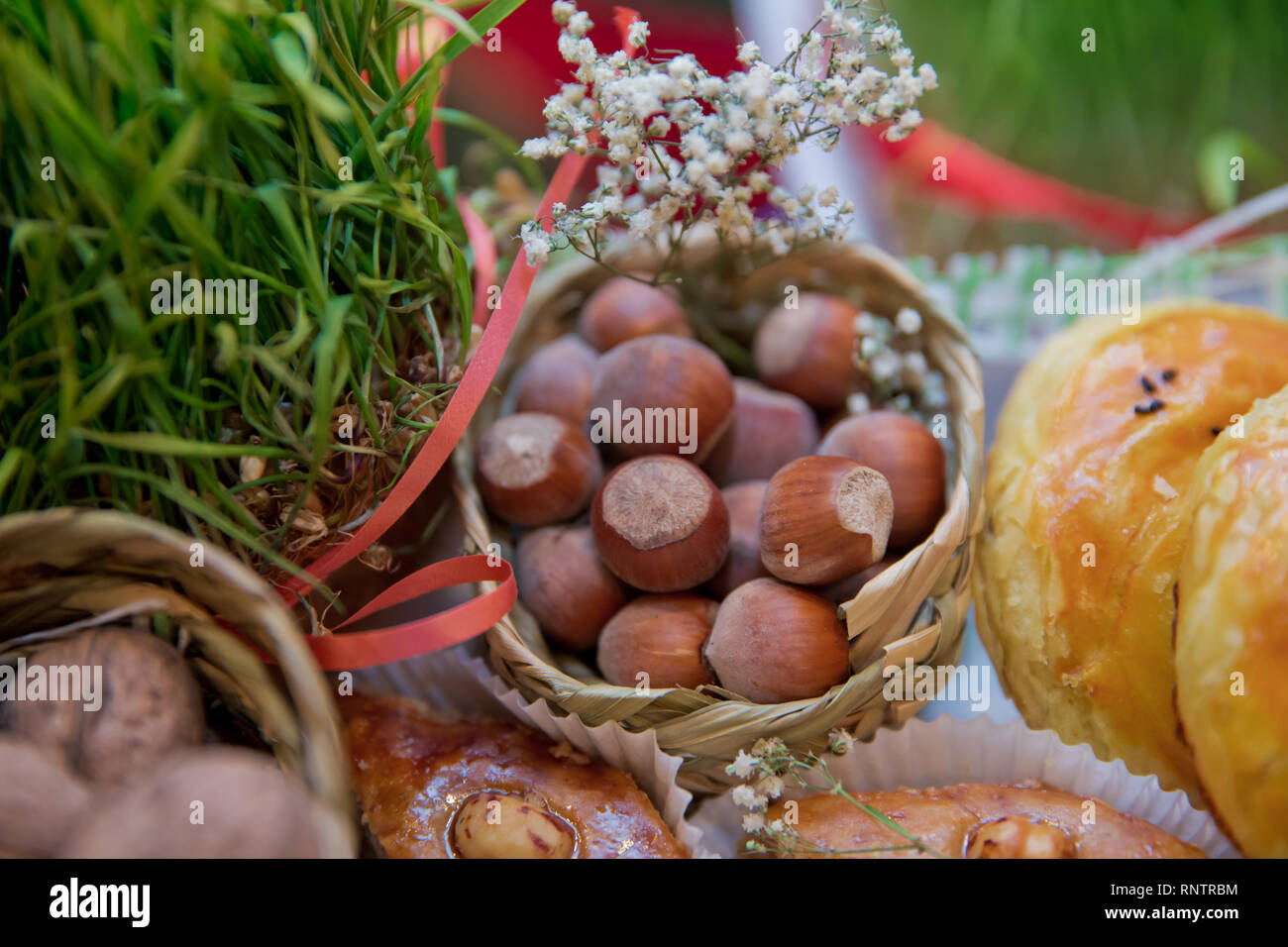 Hazel in a small basket . Close-up of hazelnuts as background . Mix of ...