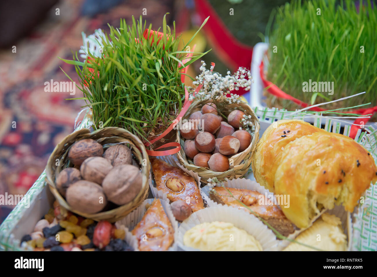 Hazel in a small basket . Close-up of hazelnuts as background . Mix of ...