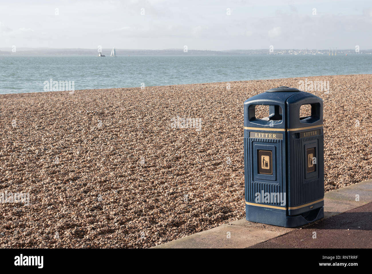litter bin next to a pebble beach Stock Photo - Alamy