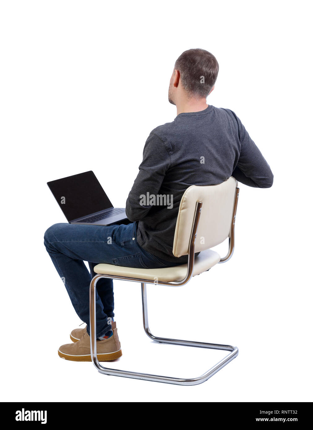 Back view of a man who sits on a chair with a laptop. Rear view people ...
