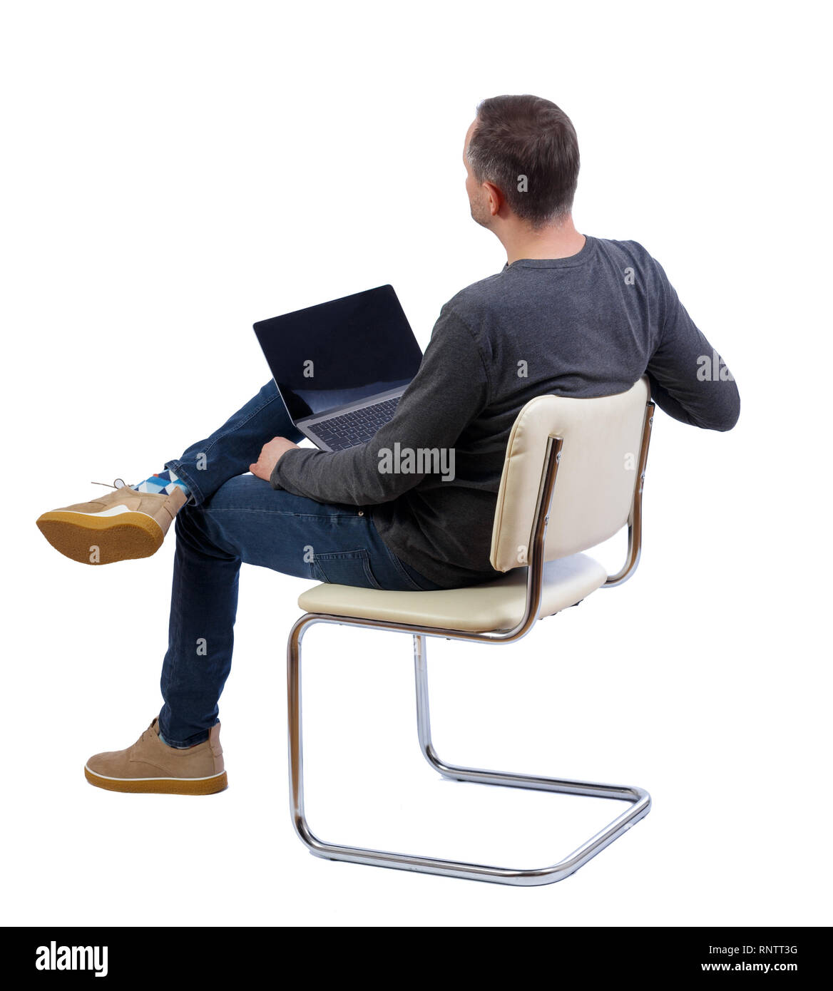 Back view of a man who sits on a chair with a laptop. Rear view people ...