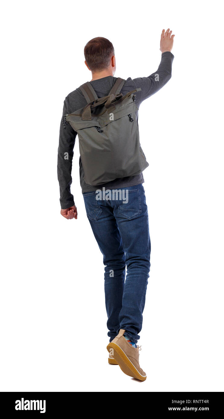 Back view of a walking man with a bag pointing his hand up. backside ...